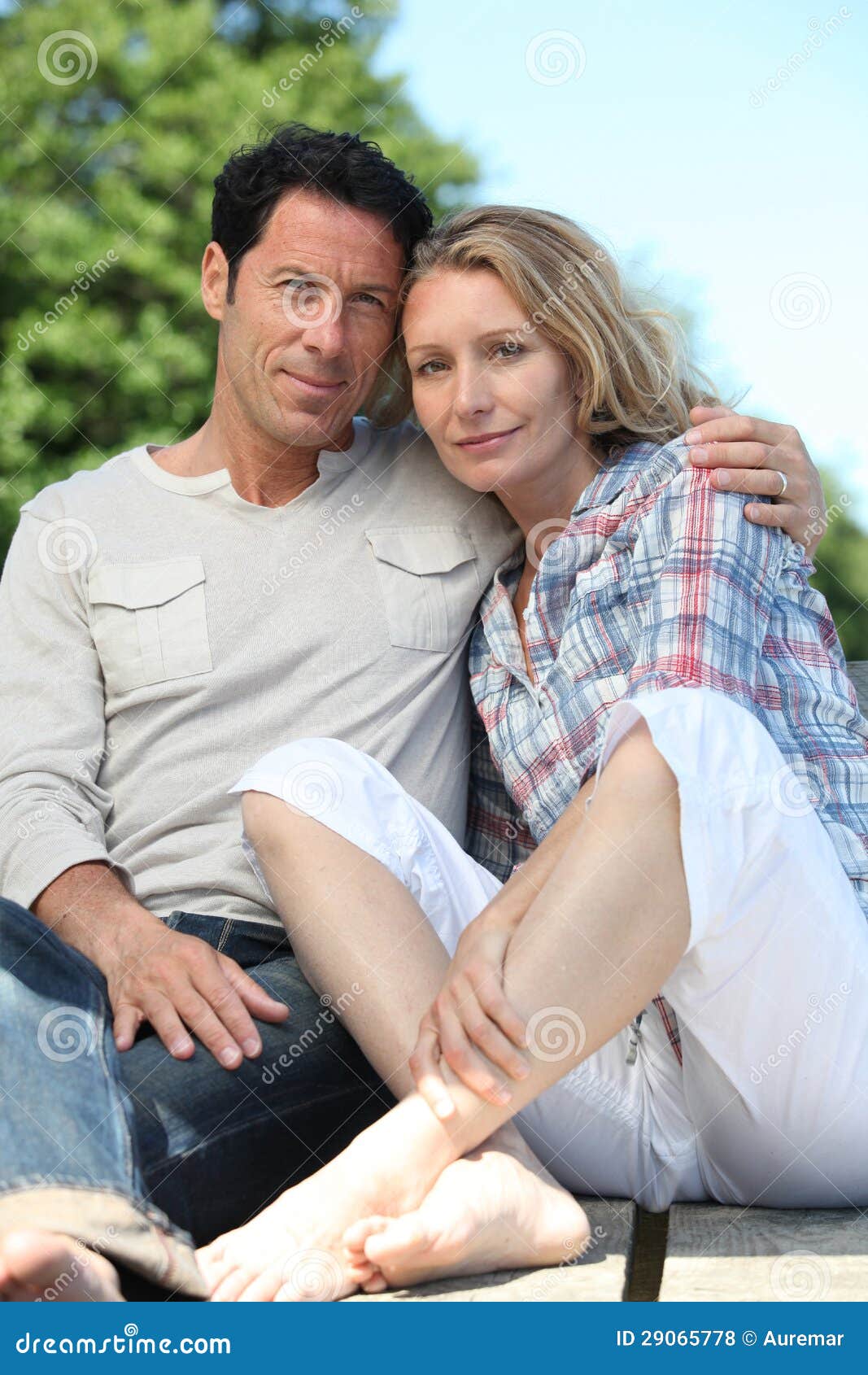 Couple sitting outside stock photo. Image of cuddle, years - 29065778