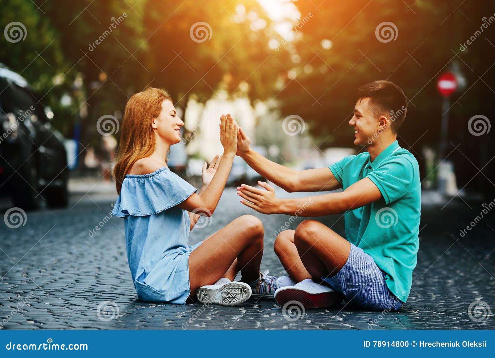 Couple Sitting on Pavement Square Stock Photo - Image of romance ...
