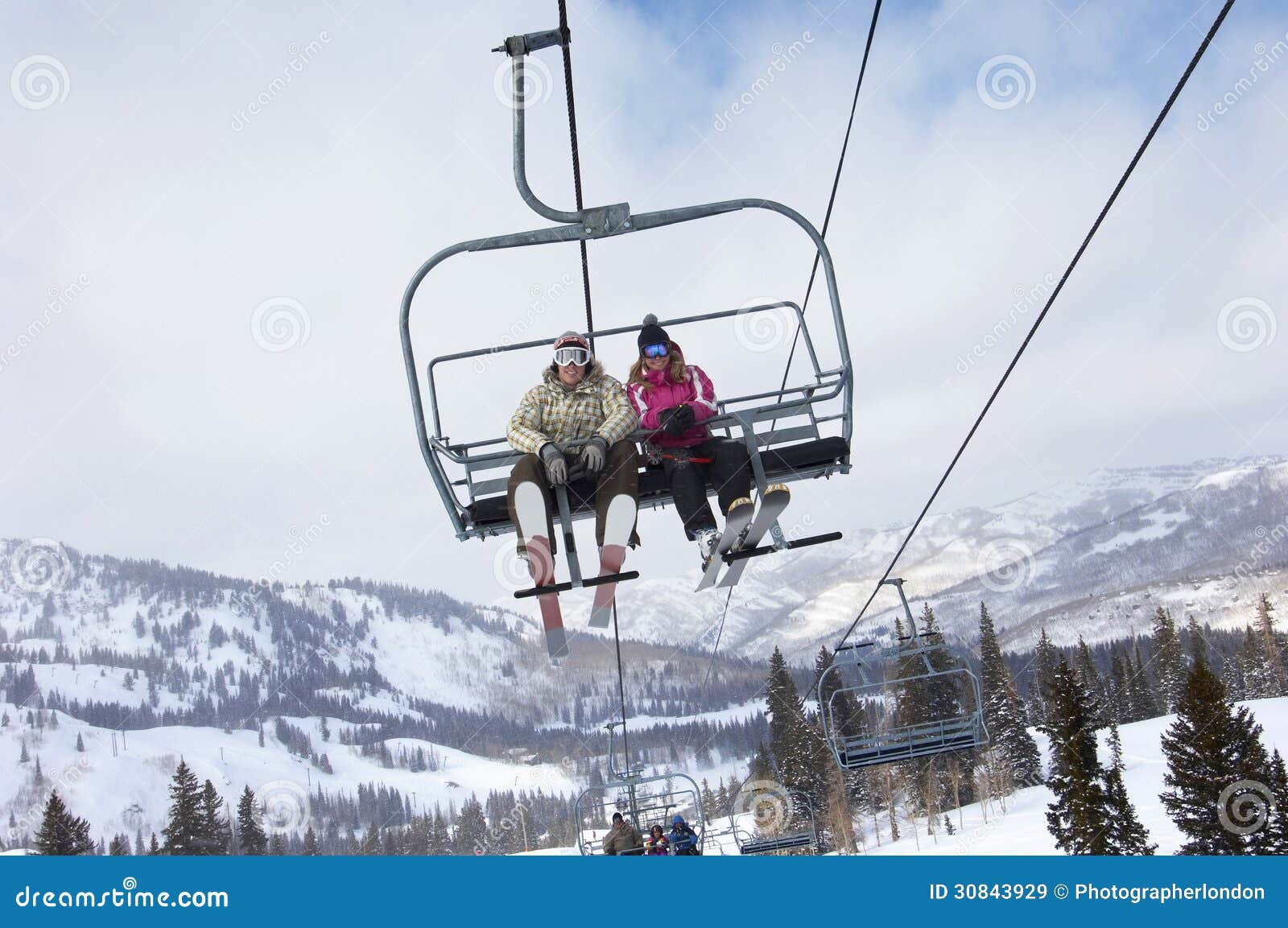 Couple Sitting on Ski Lift stock image. Image of extreme - 30843929