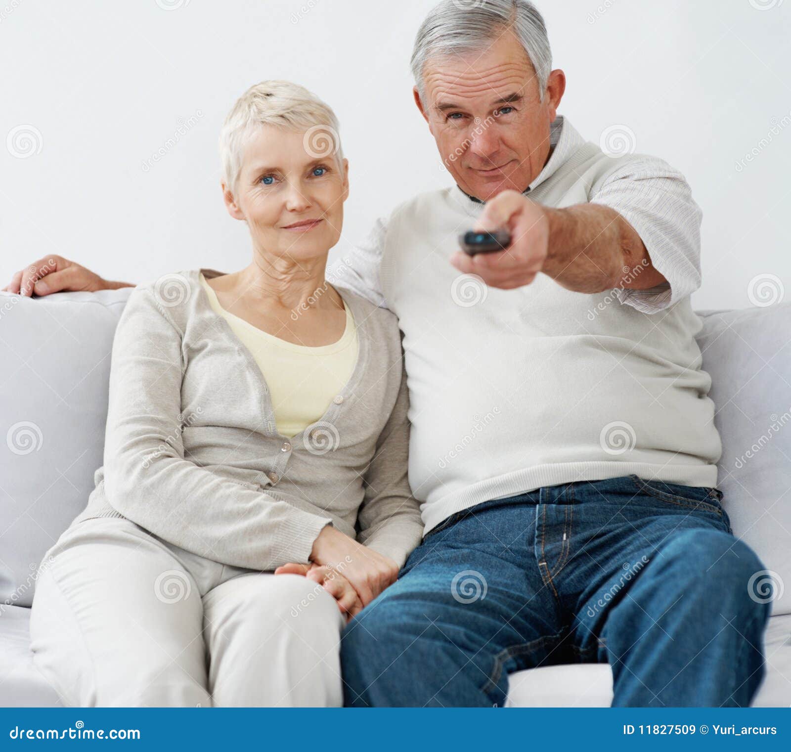 Couple Sitting on a Sofapointing Remote Control Stock Image - Image of ...