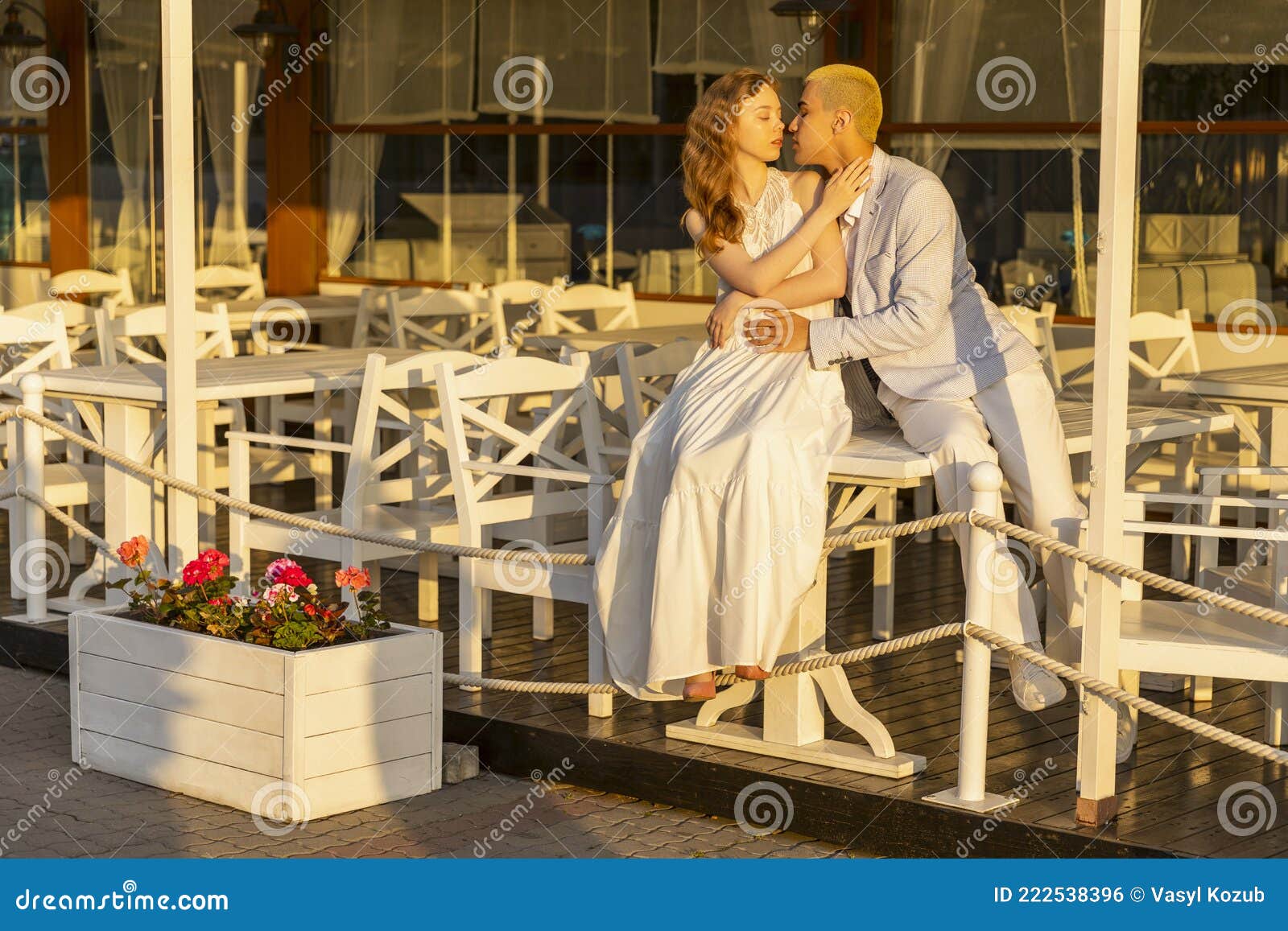 Couple Sitting on the Table Stock Photo - Image of outdoors, together ...