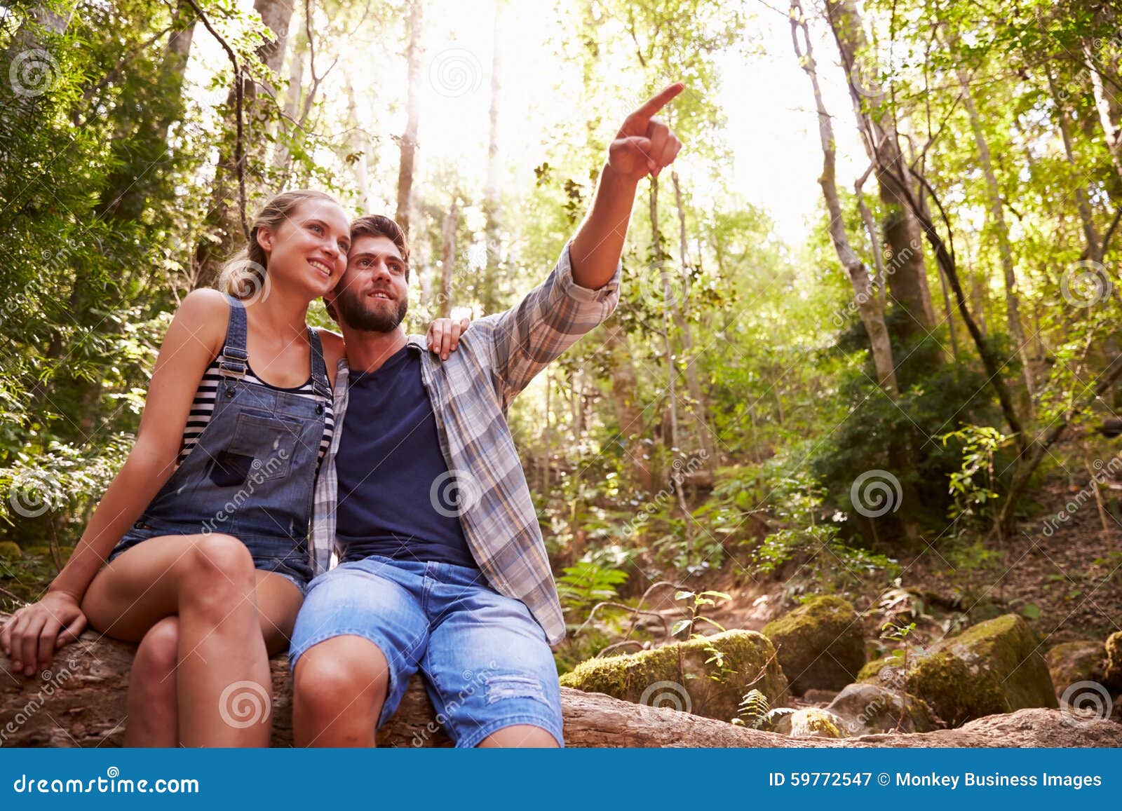 Couple Sitting on Tree Trunk in Forest Together Stock Image - Image of ...