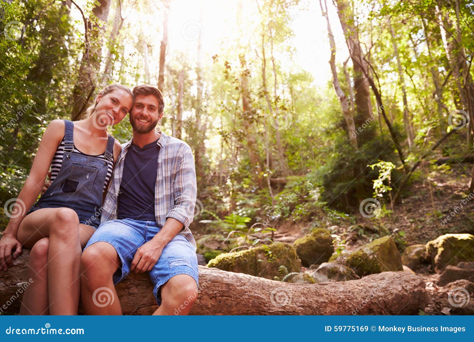 Couple Sitting on Tree Trunk in Forest Together Stock Image - Image of ...