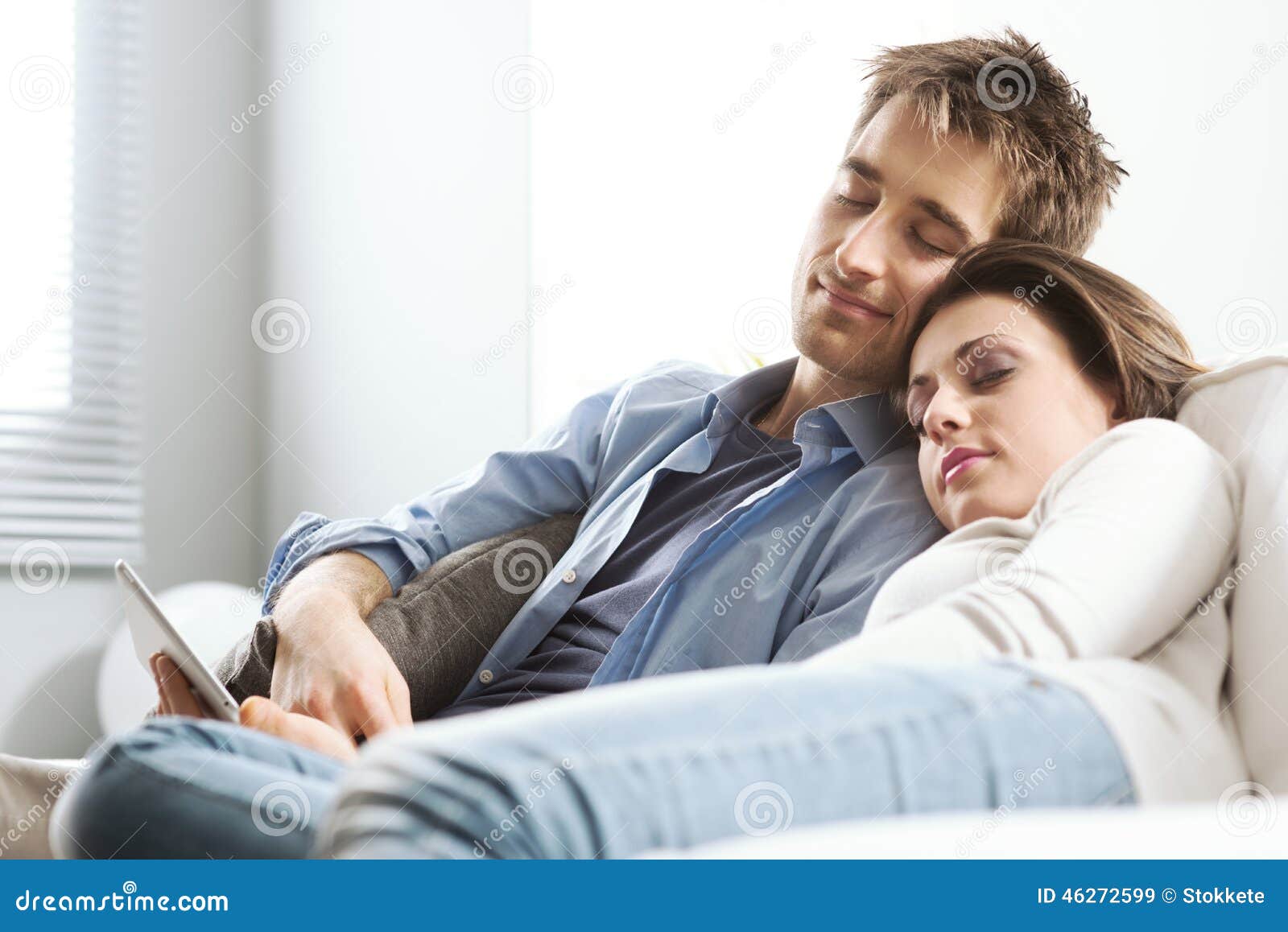 Couple sleeping on sofa stock image. Image of interior - 46272599