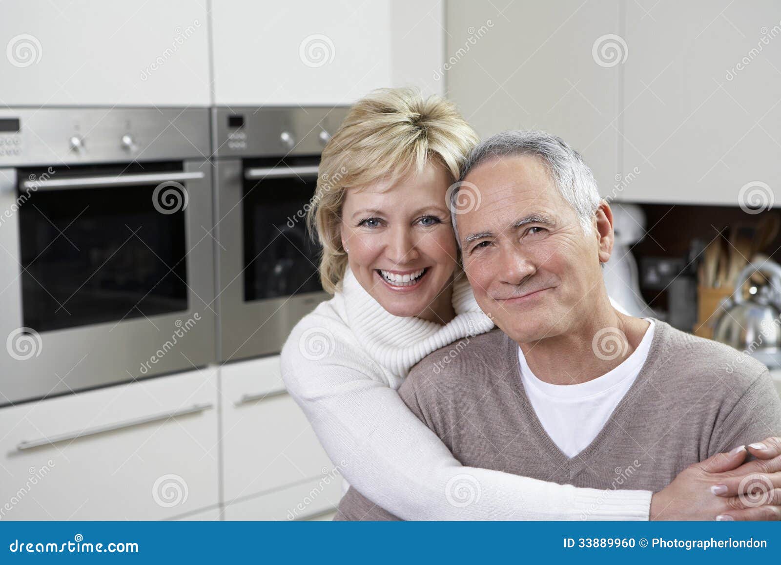 Couple Smiling in Kitchen stock photo. Image of male - 33889960