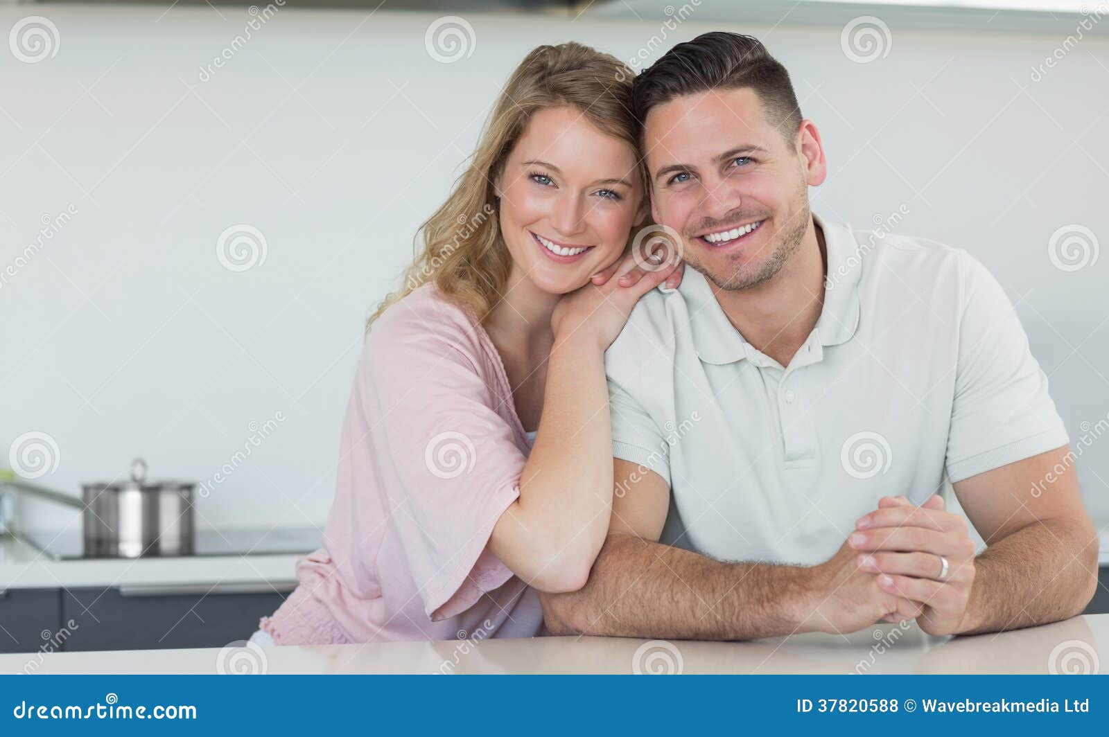 Couple Smiling at Kitchen Counter Stock Photo - Image of front, worktop ...