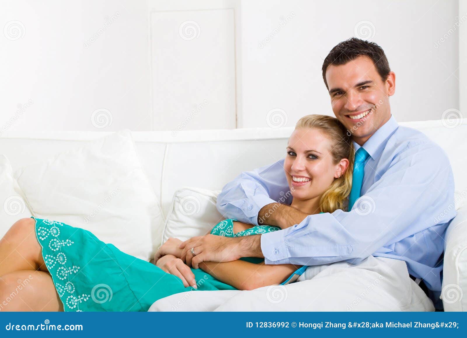 Couple on sofa stock photo. Image of dress, care, arms - 12836992