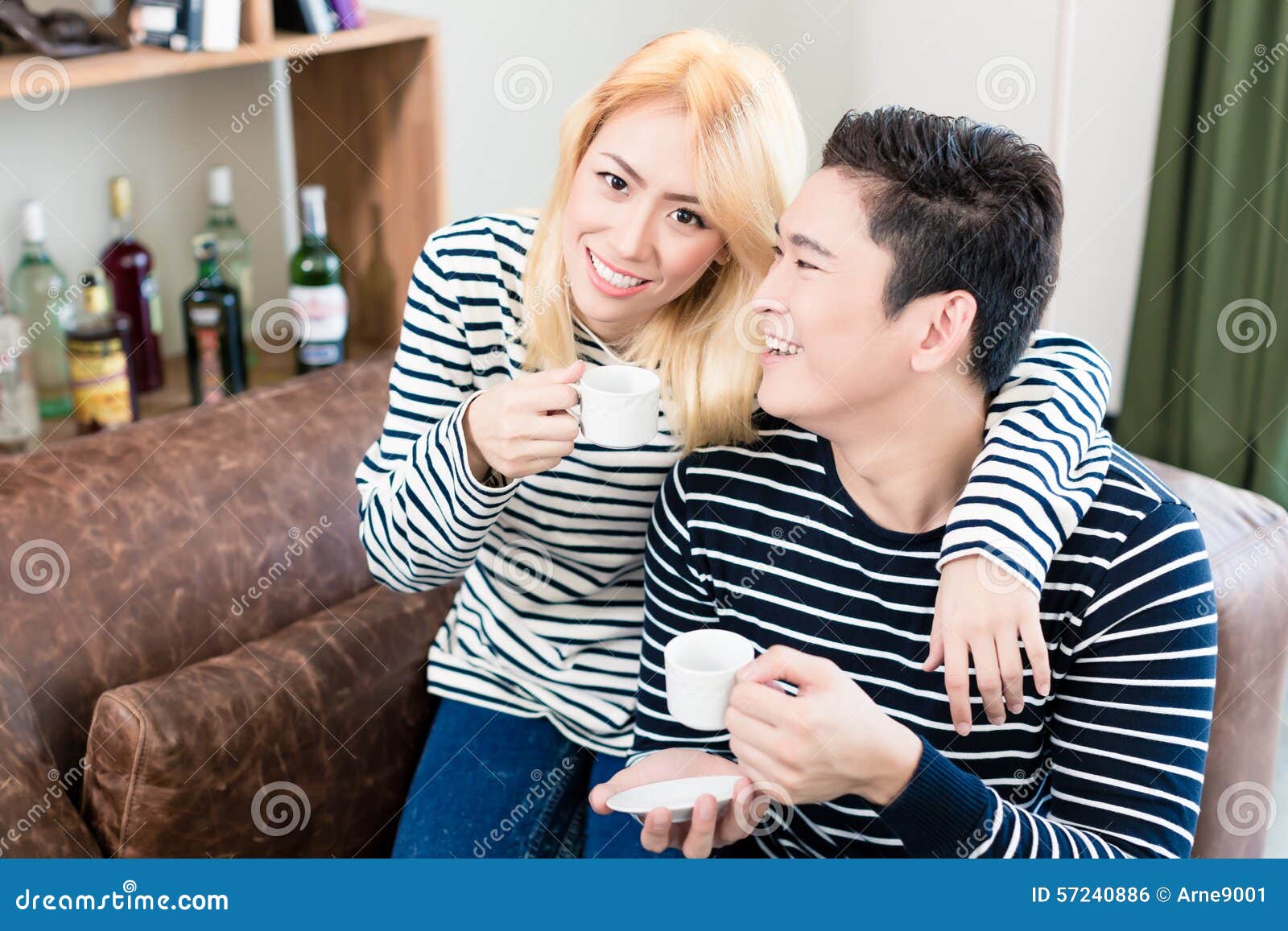 Couple on Sofa Drinking Coffee Together Stock Photo - Image of sitting ...