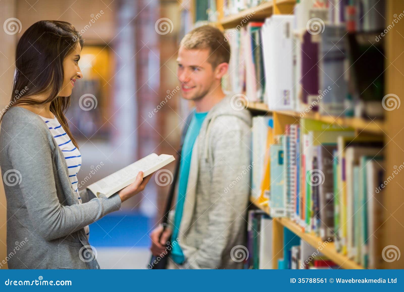 Couple Standing Against Bookshelf in Library Stock Image - Image of ...