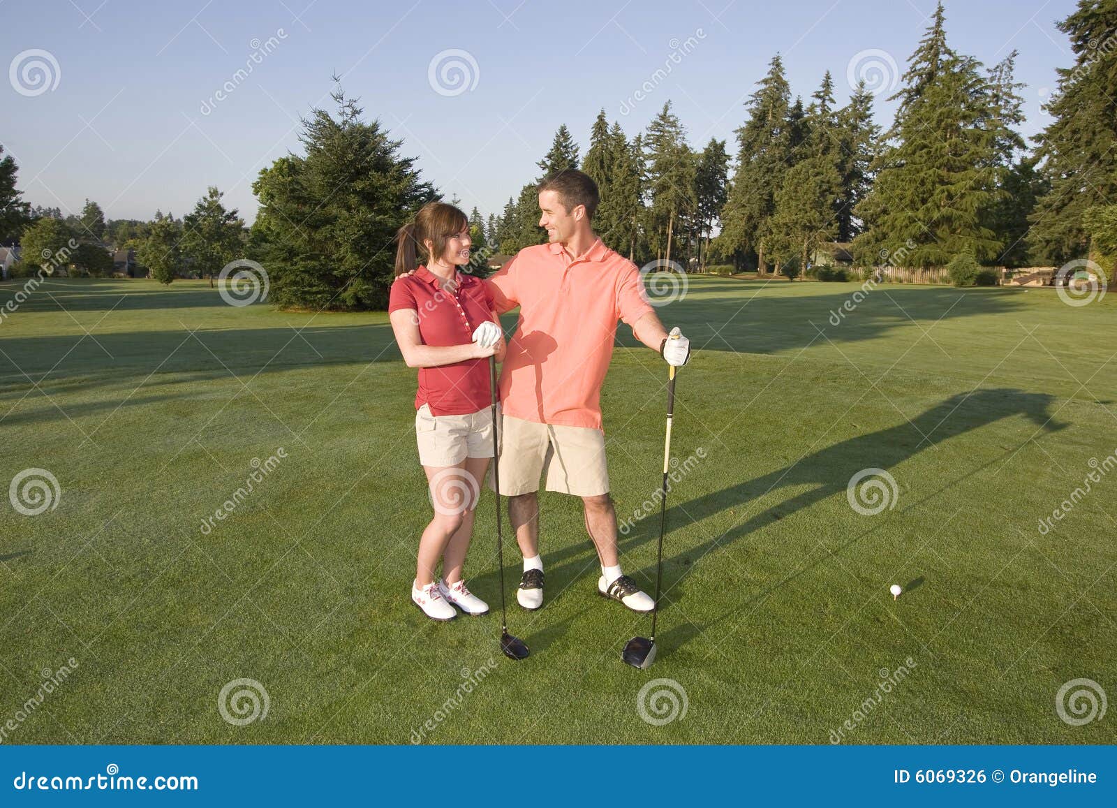 Couple Standing on Golf Course - Horizontal Stock Photo - Image of ...