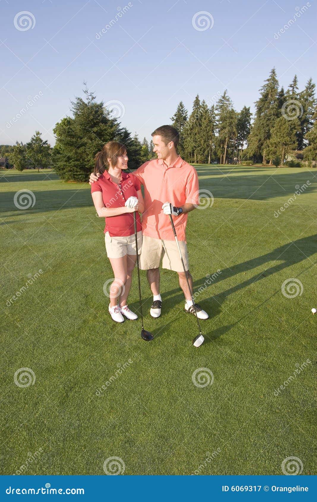 Couple Standing on Golf Course - Vertical Stock Image - Image of clubs ...