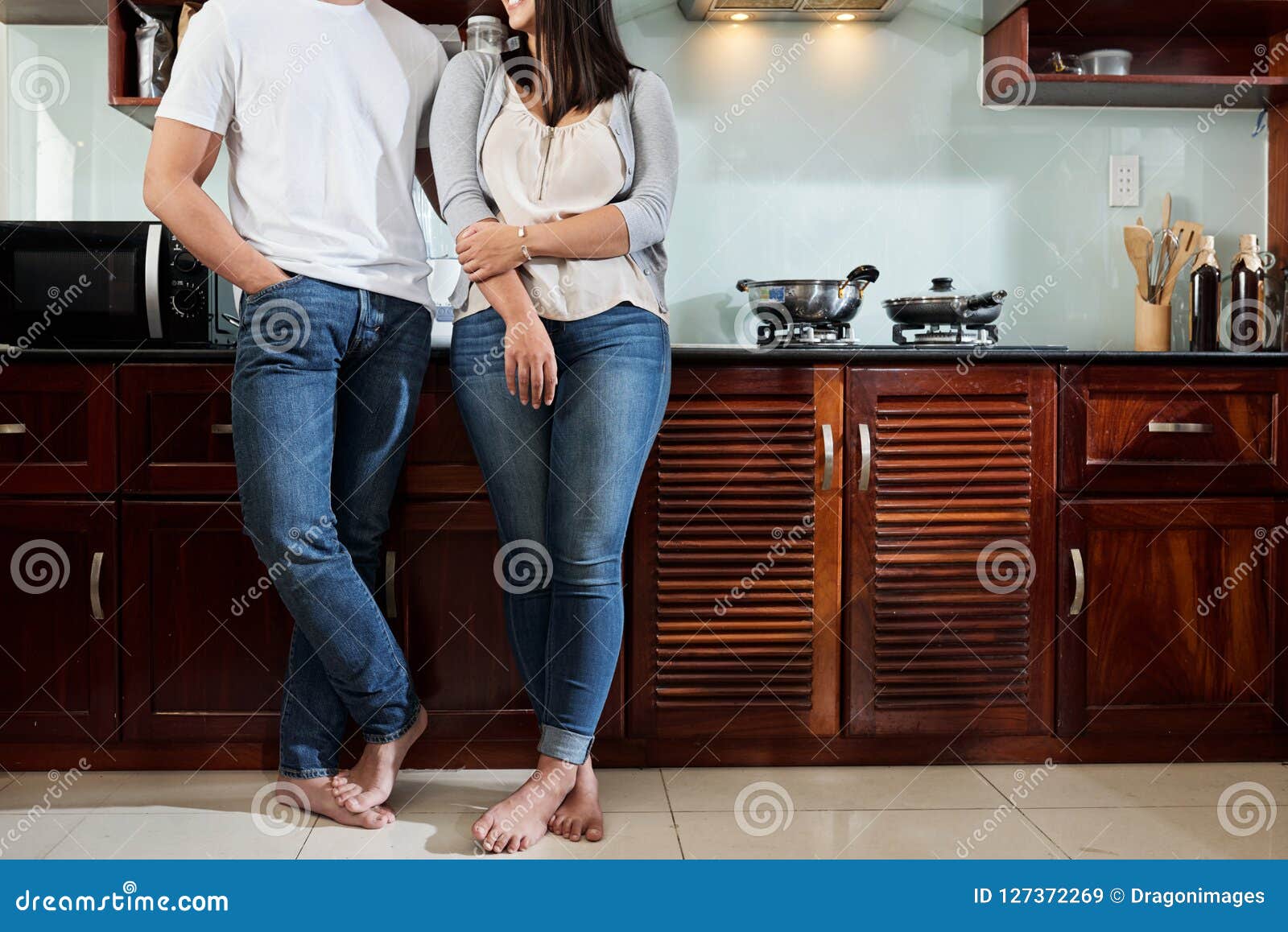 Couple standing in kitchen stock image. Image of people - 127372269