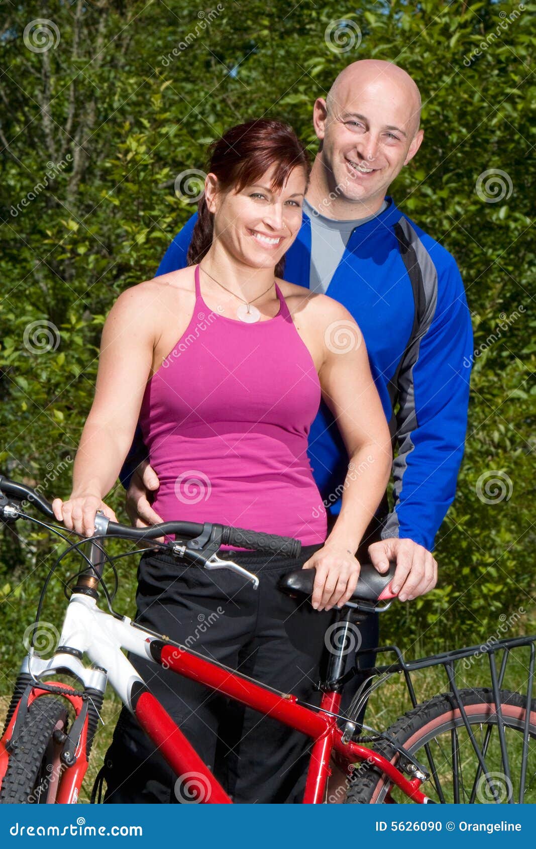 Couple Standing Next To Bike - Vertical Stock Photo - Image of people ...