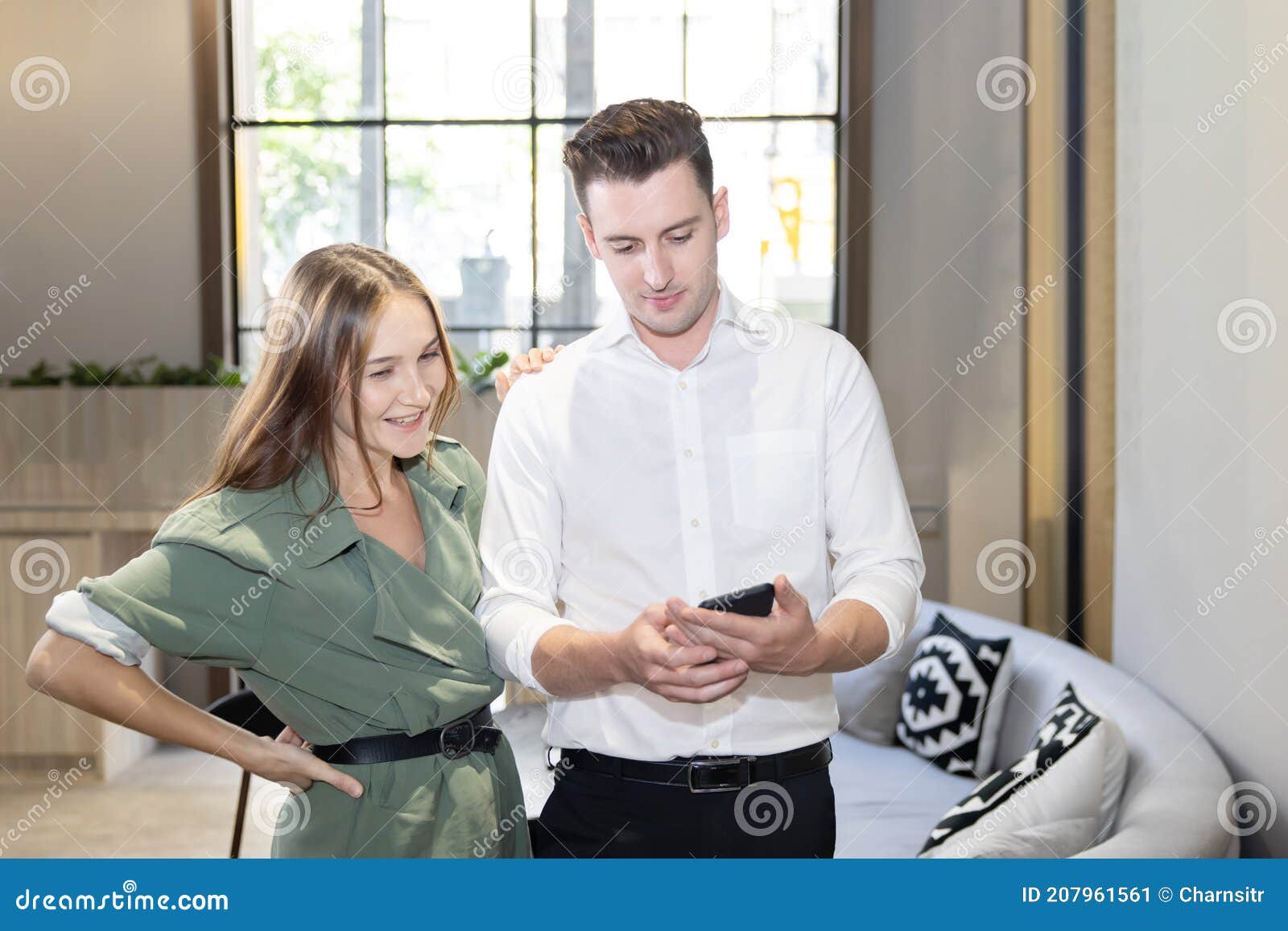 Couple Standing and Watching Mobile Phone Screen Stock Image - Image of ...