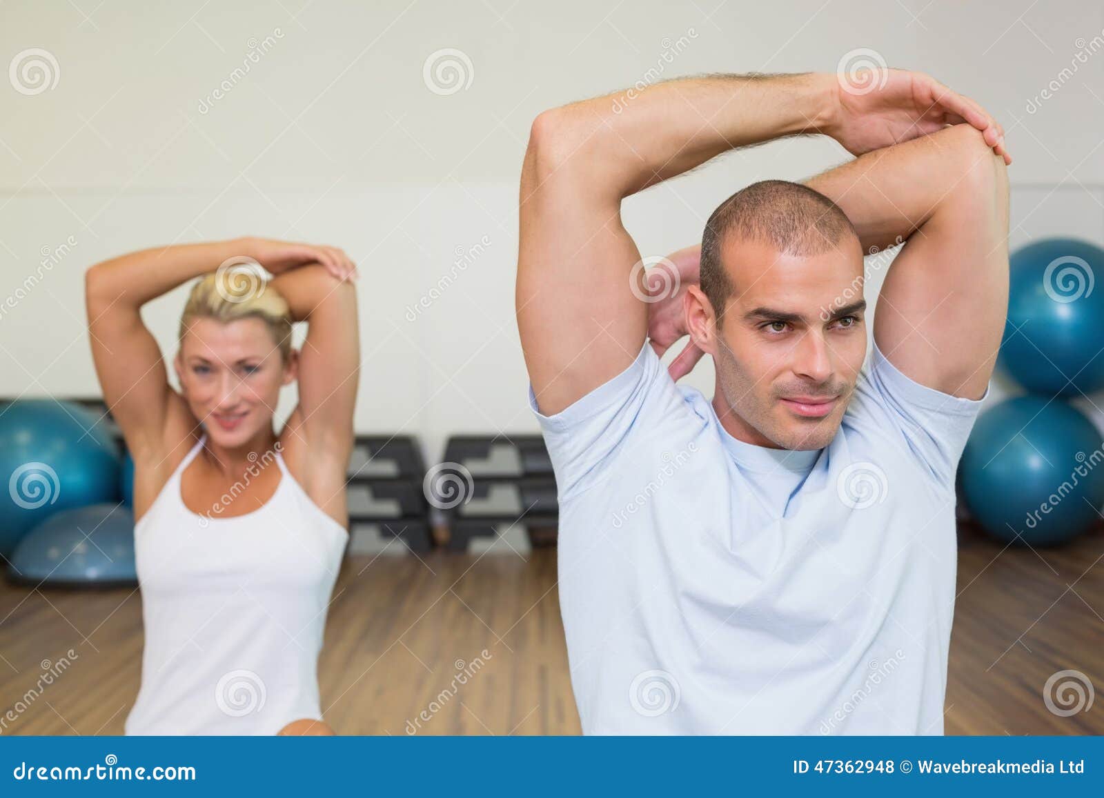 Couple Stretching Hands Behind Back in Yoga Class Stock Photo - Image ...