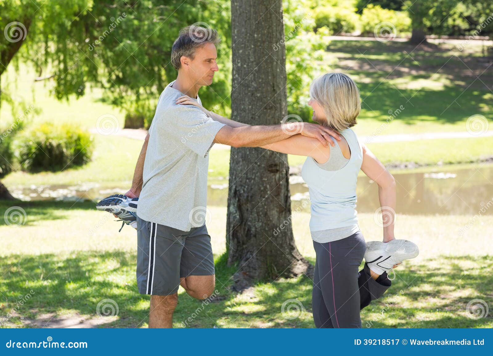 Couple Stretching Legs in Park Stock Image - Image of three, summer ...