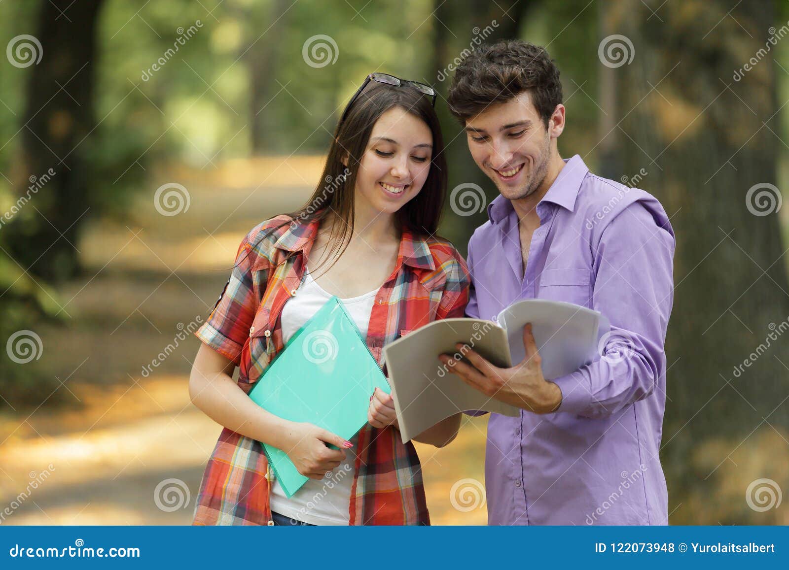 Couple of Students Discuss Their Records while Standing in the Park ...