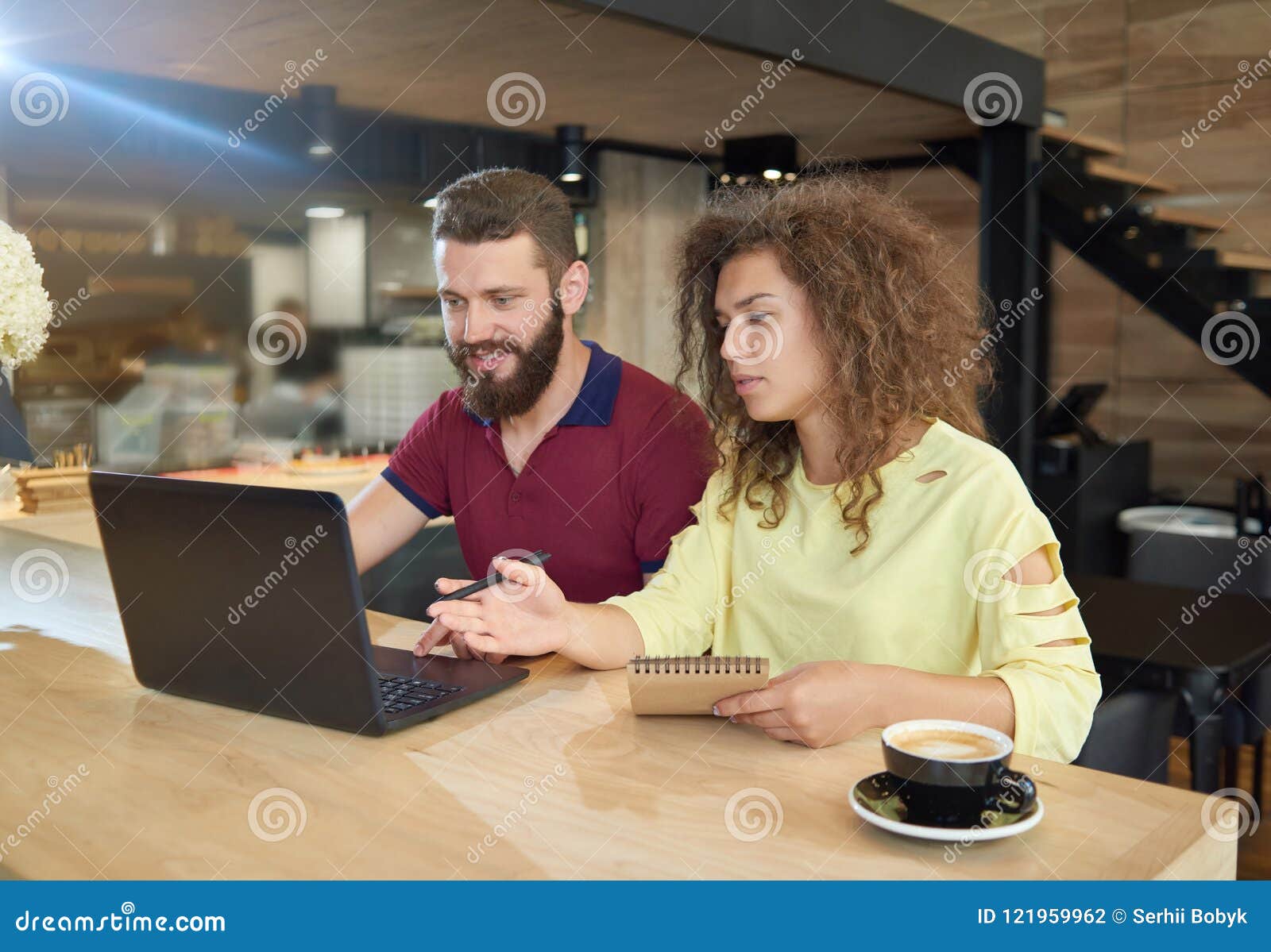 Couple of Students Studying in Cafe Using Laptop. Stock Photo - Image ...