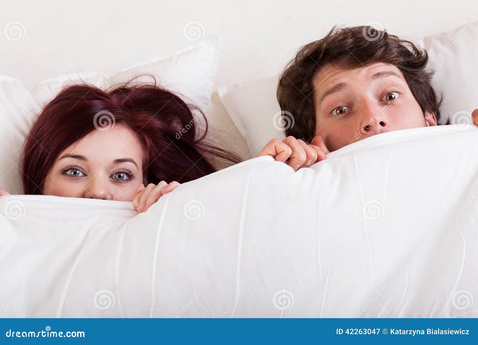 Couple surprised in bed stock image. Image of bedroom - 42263047