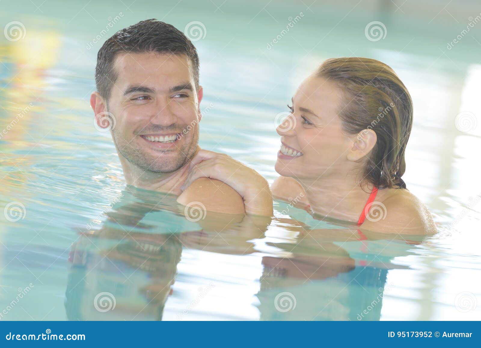 Couple swimming in pool stock photo. Image of love, health - 95173952