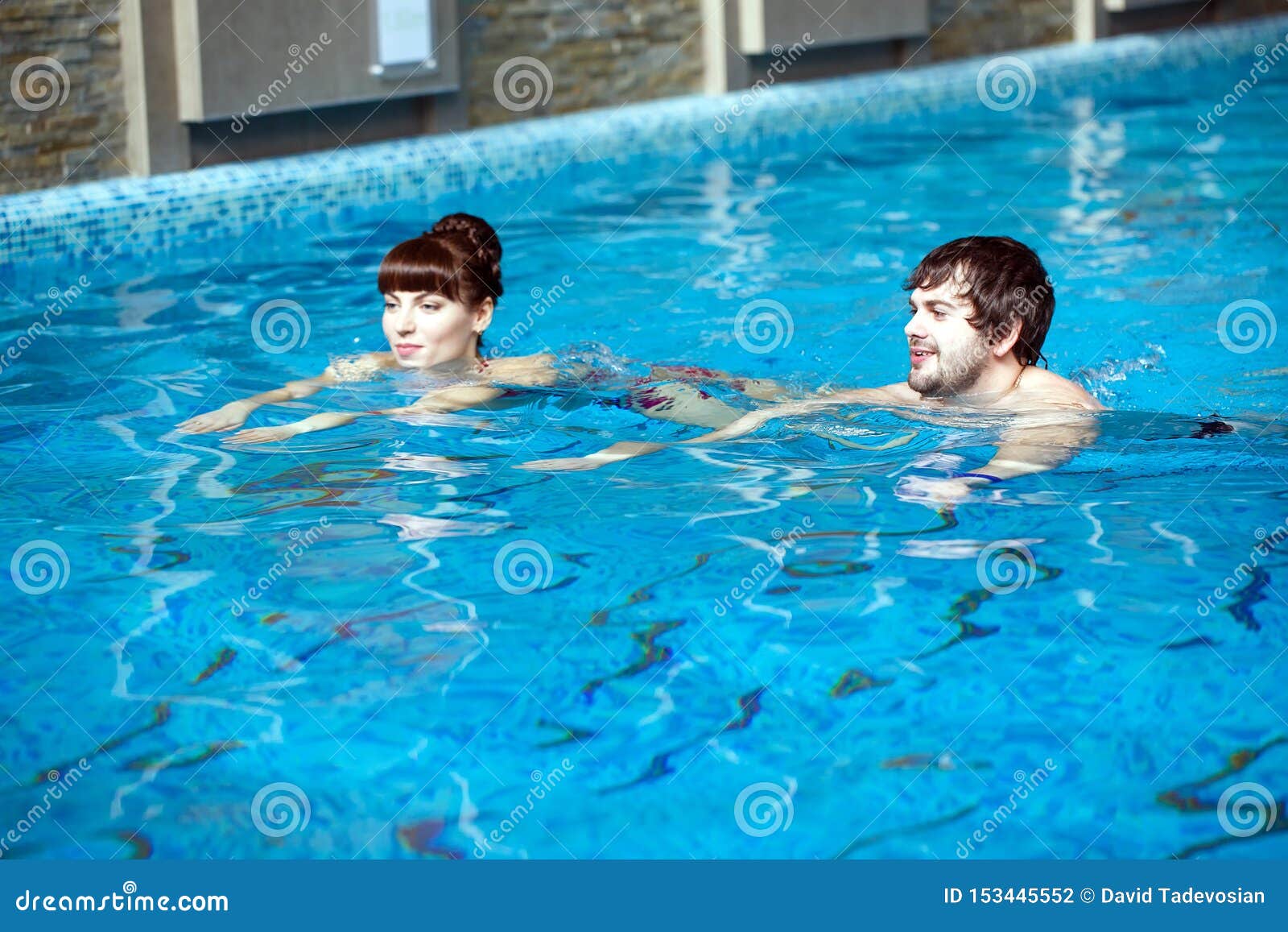 Couple Swimming in the Pool. Lovers Spend Time Together in the Pool ...