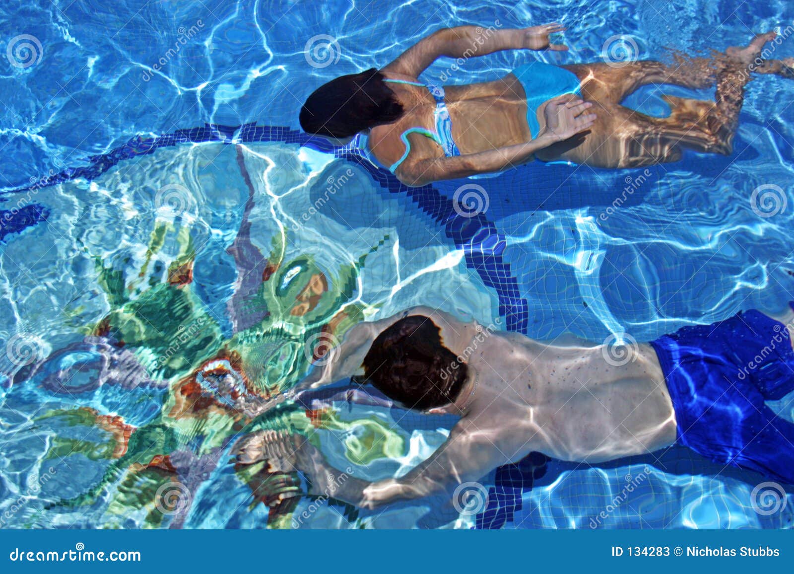 Couple Swimming Underwater in Clear Blue Pool Stock Image - Image of ...