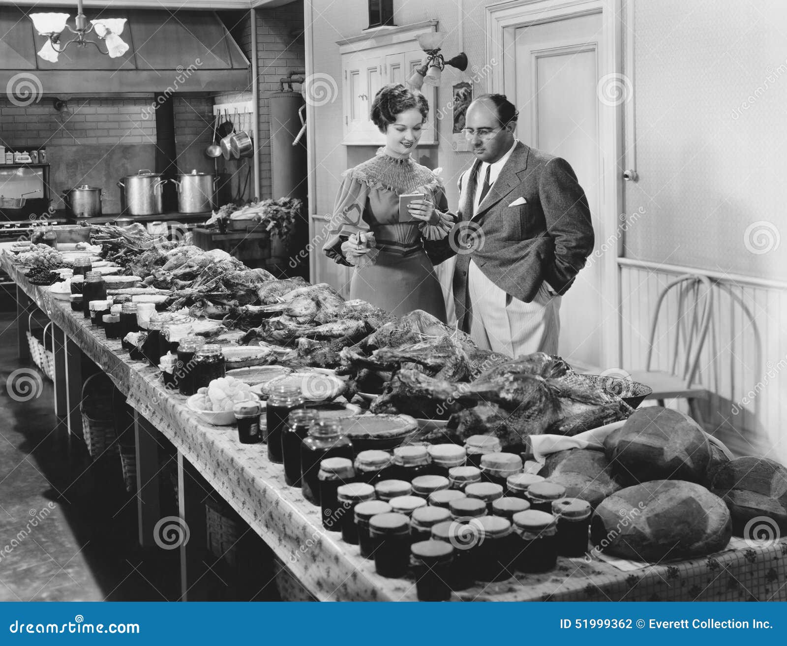 Couple with Table Covered in Food for Holiday Meal Stock Photo - Image ...