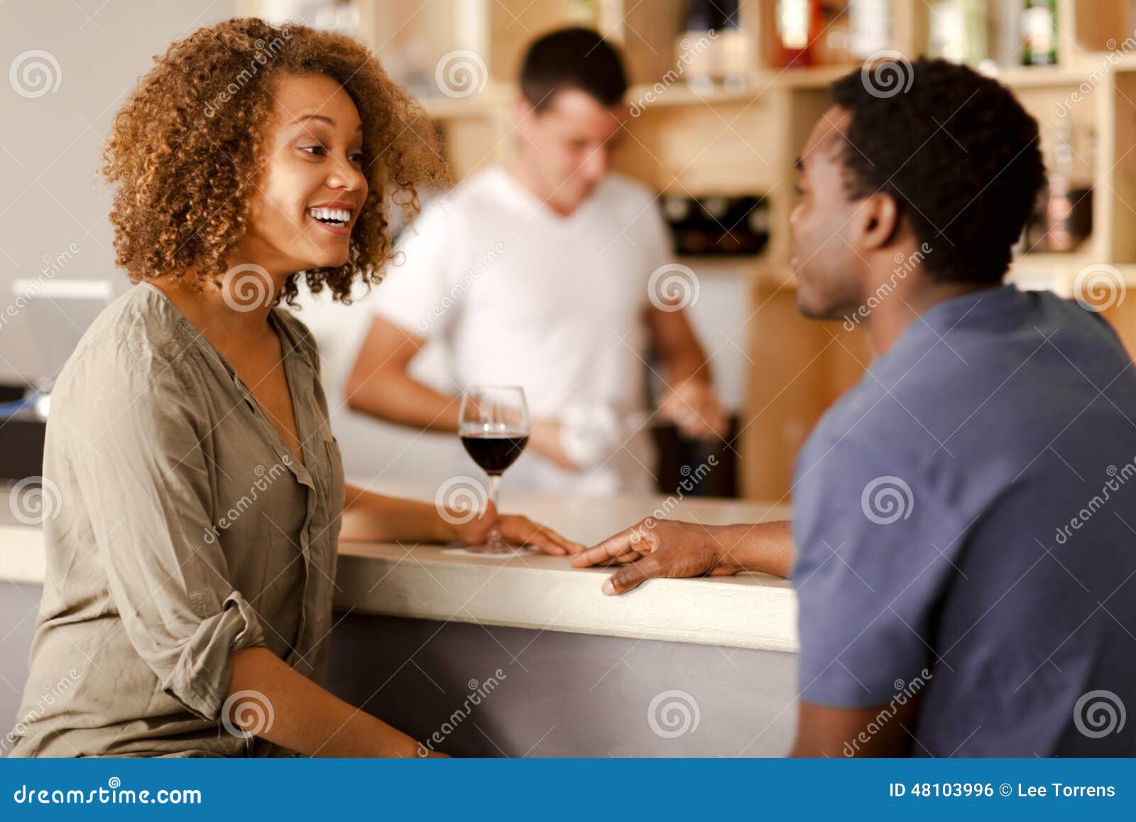 Couple talking in a bar stock photo. Image of beautiful - 48103996