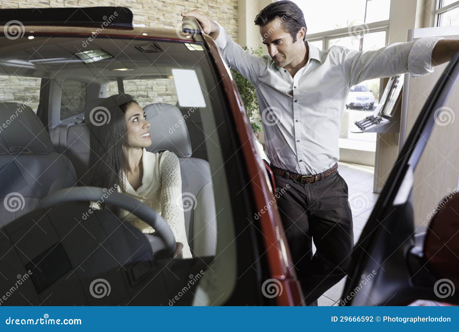 Couple Talking in Car Show Room Stock Photo - Image of casual, male ...