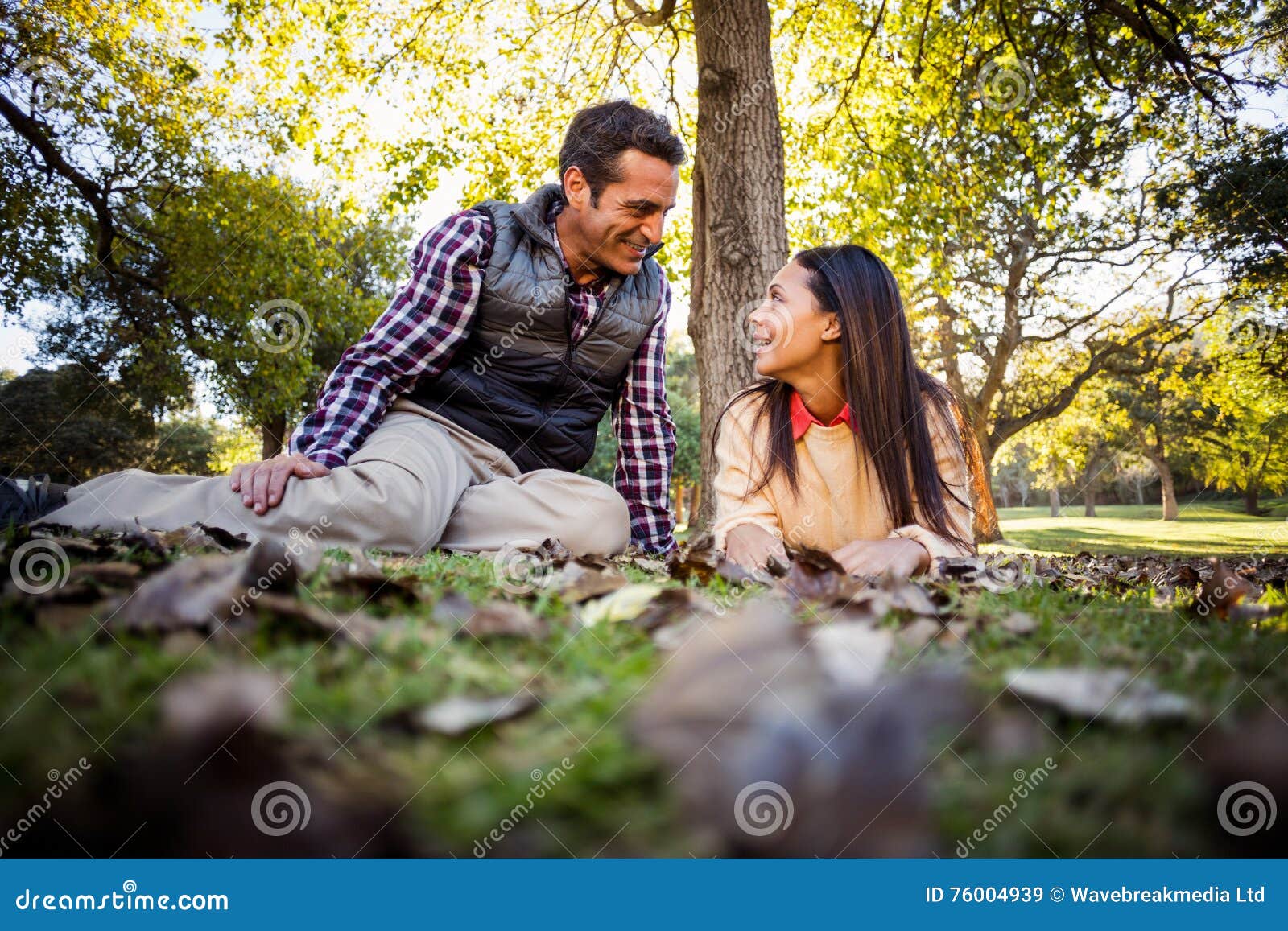 Couple talking at park stock image. Image of face, fondness - 76004939