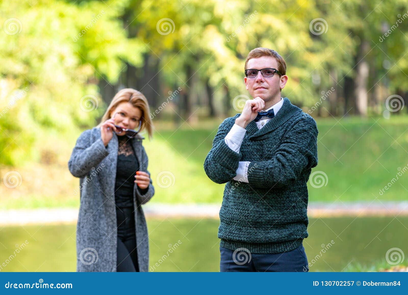 Couple Talking Seriously Outdoors in a Park with a Green Background ...