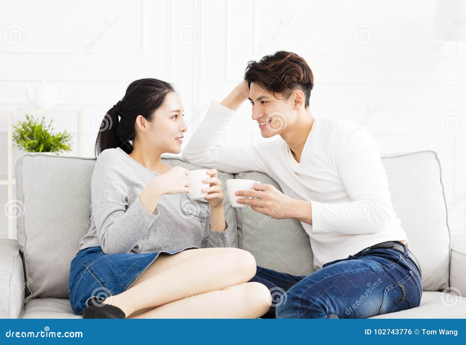 Couple Talking and Sitting on Sofa Stock Photo - Image of couple ...