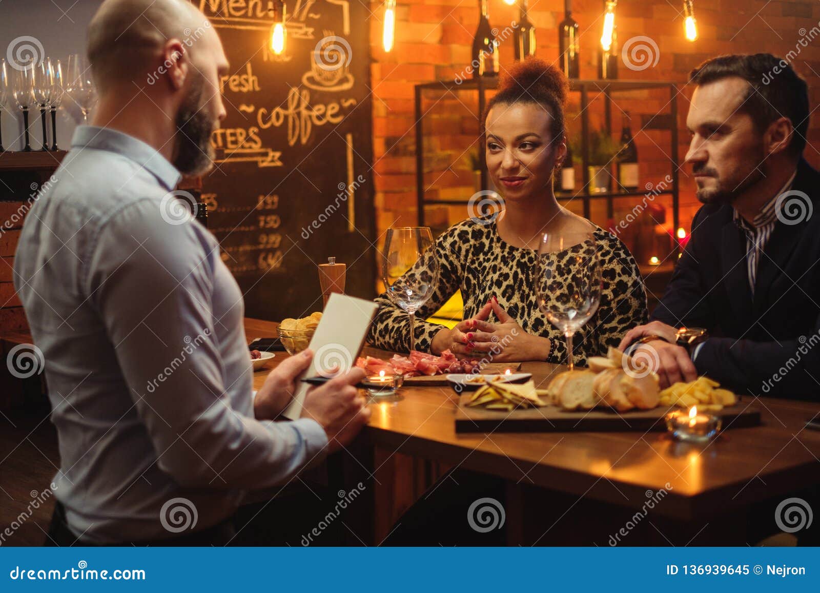 Couple Talking To Bartender Behind Bar Counter in a Cafe Stock Image ...