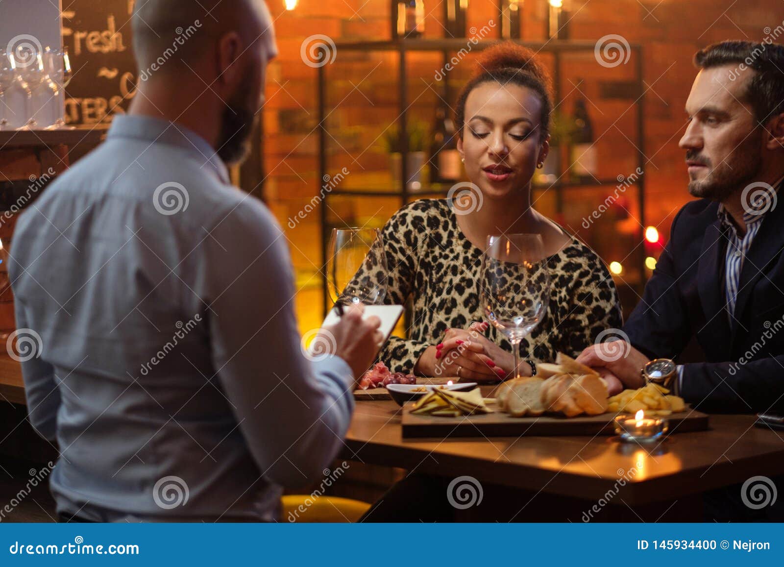 Couple Talking To Bartender Behind Bar Counter in a Cafe Stock Photo ...