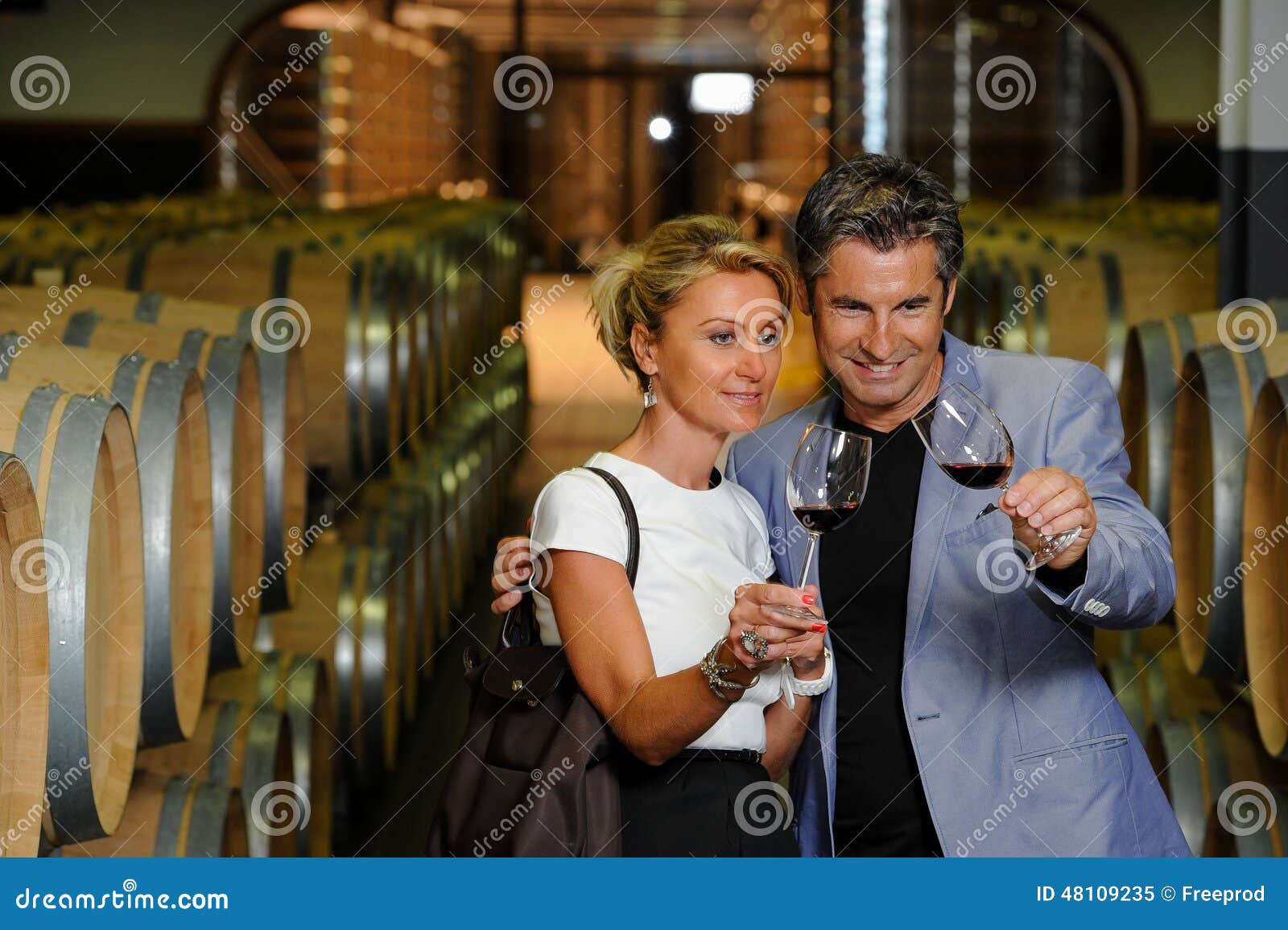 Couple Tasting Wine in a Cellar Stock Image - Image of container ...