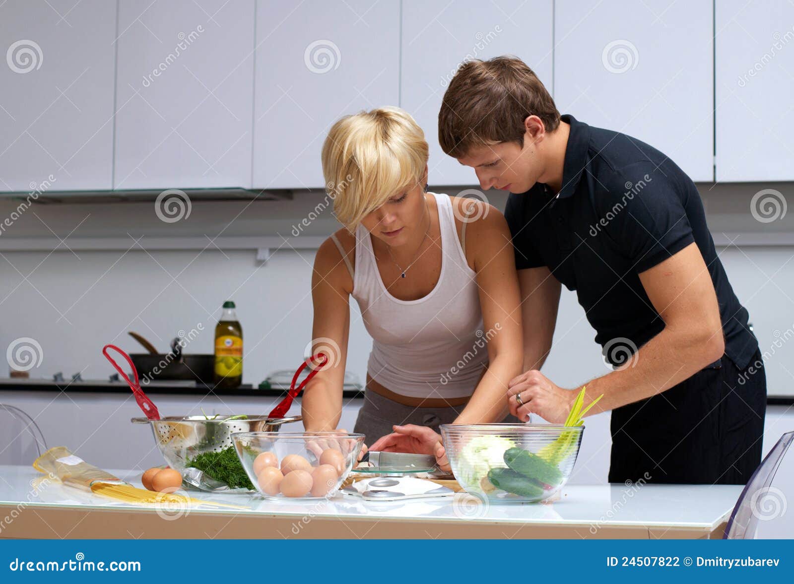Couple in Their Kitchen Making Dinner Stock Photo - Image of house ...