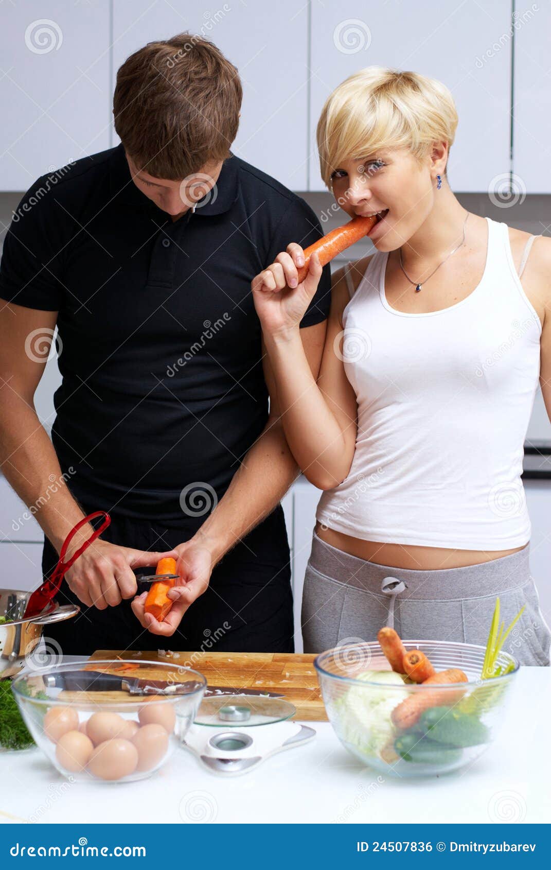 Couple in Their Kitchen Making Dinner Stock Photo - Image of male ...