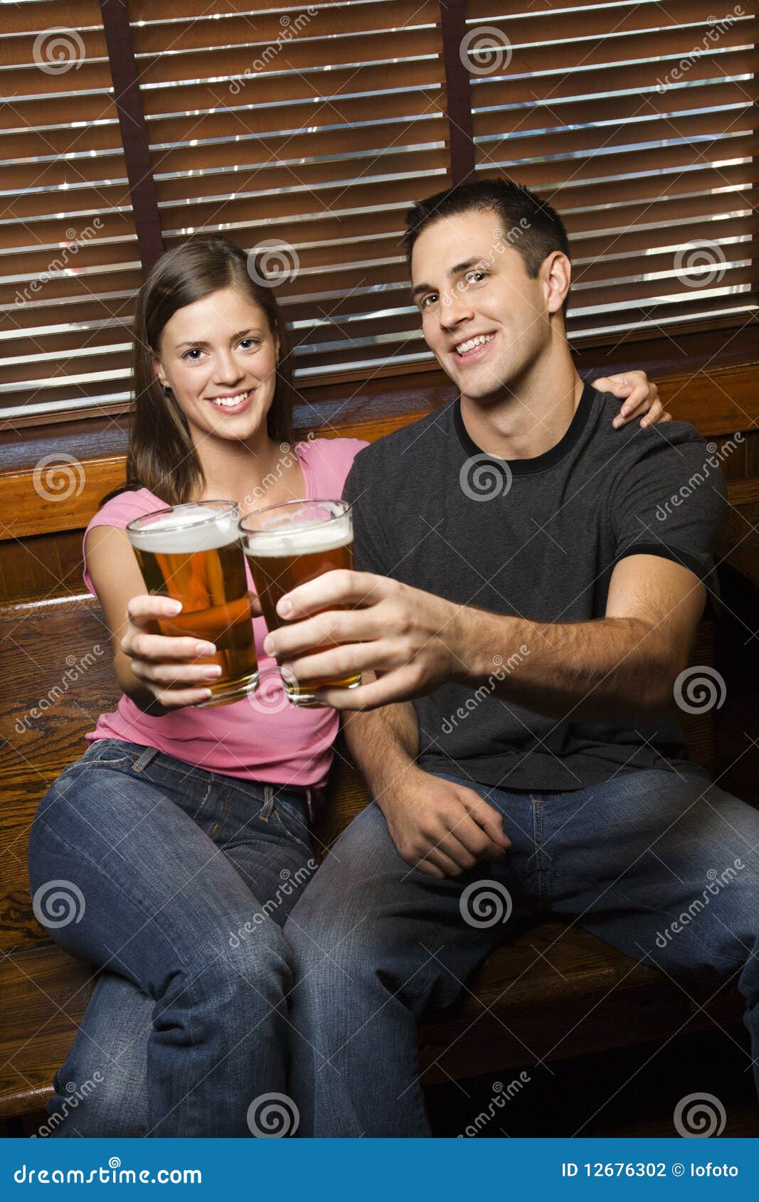Couple Toasting Their Beers Stock Photo - Image of nightlife, couple ...