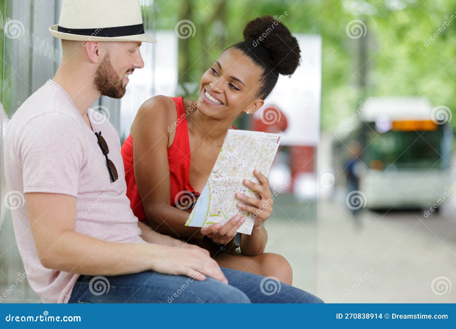Couple with Tourist Map Sitting in Bus Stop Stock Photo - Image of ...