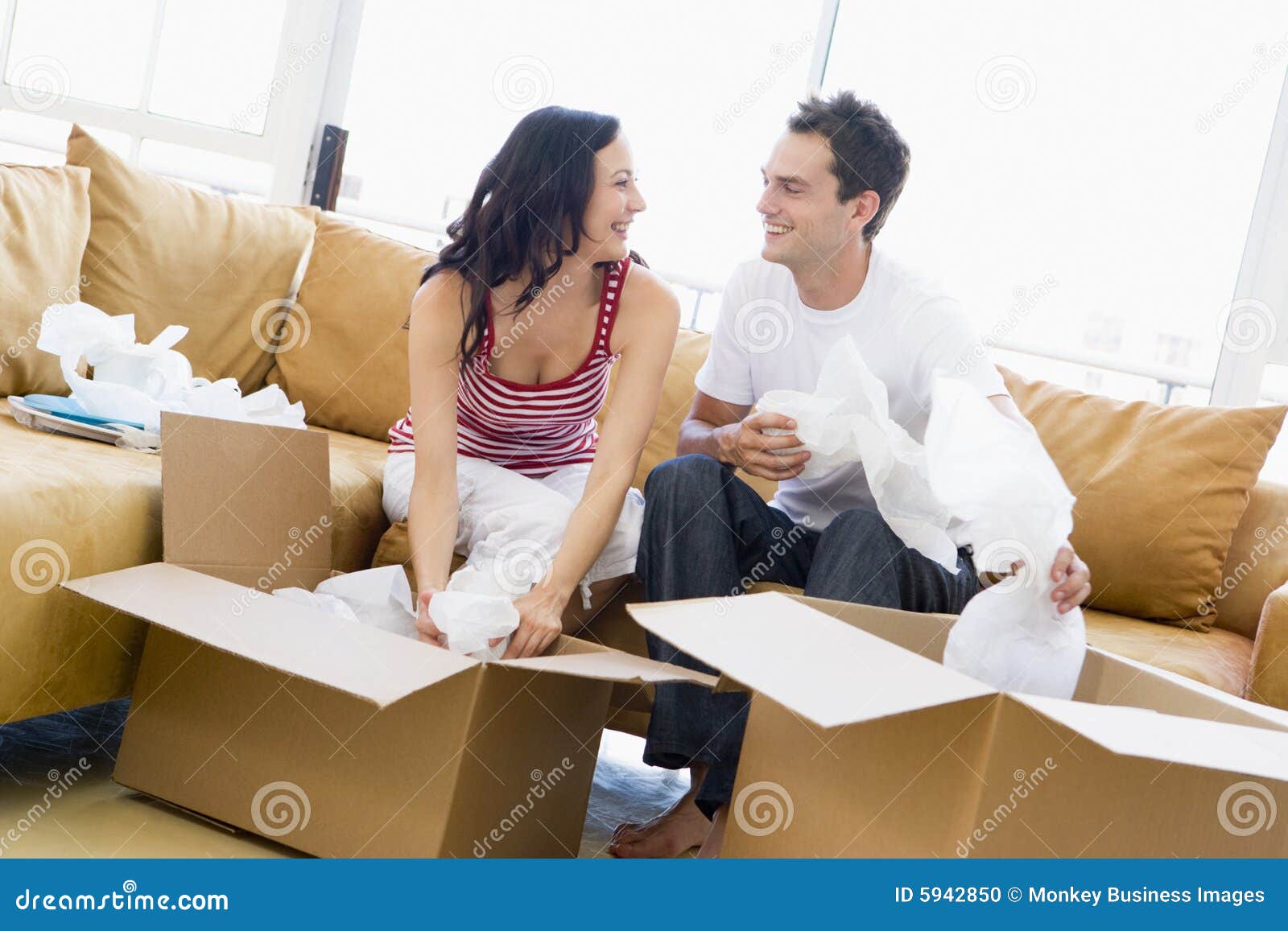 Couple Unpacking Boxes in New Home Stock Photo - Image of male ...