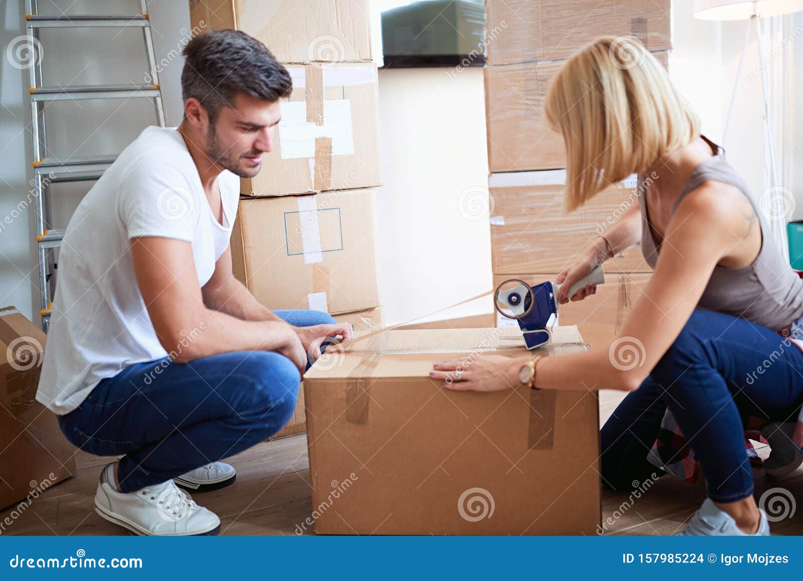 Couple Unpacking Boxes in New Home Stock Photo - Image of container ...
