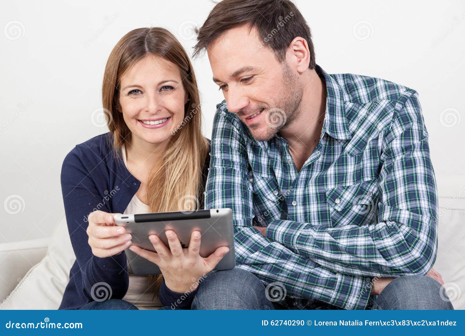 Couple using the ipad stock photo. Image of computer - 62740290