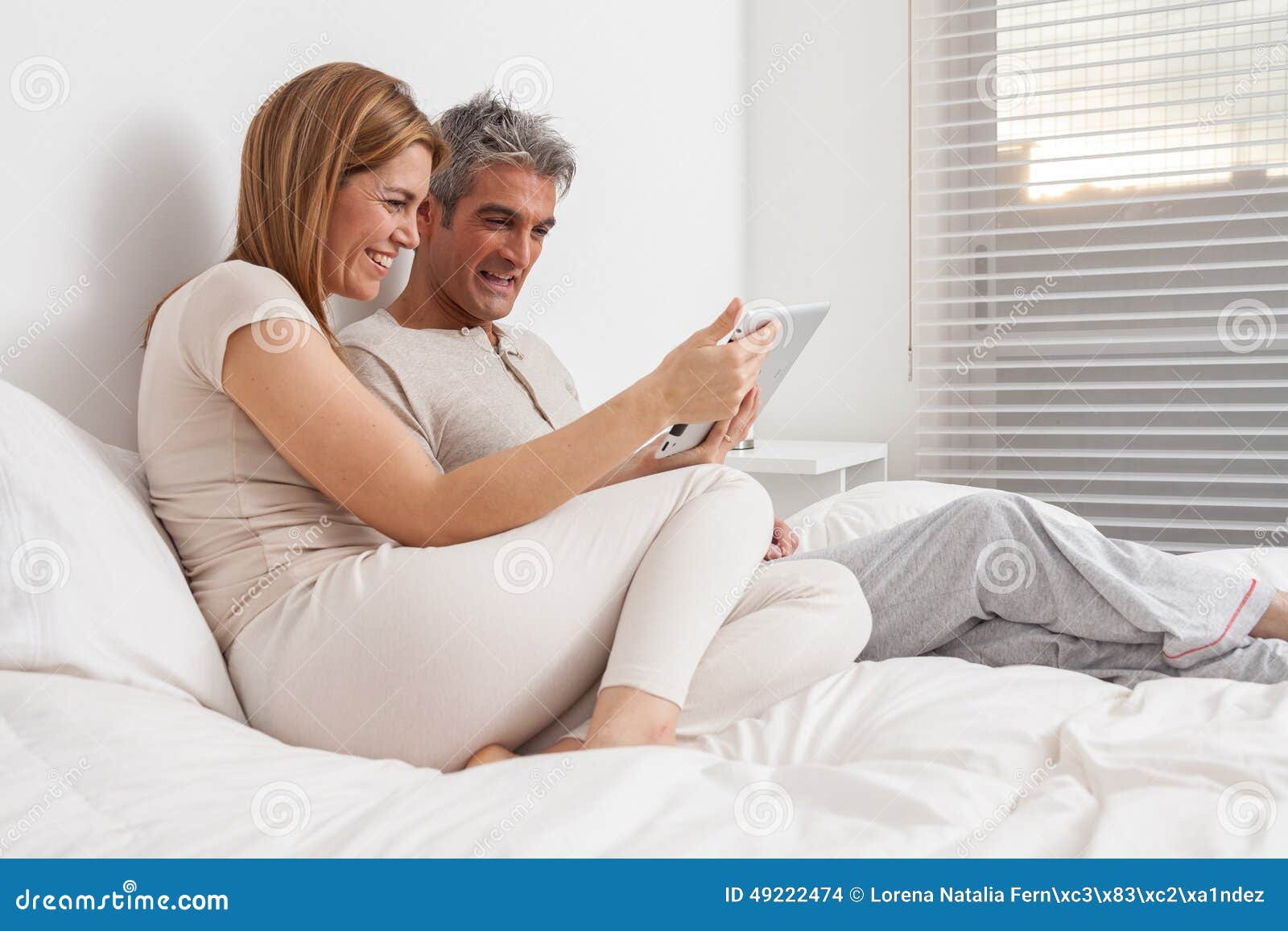 Couple Using the Ipad in the Bed Stock Photo - Image of ipad, young ...