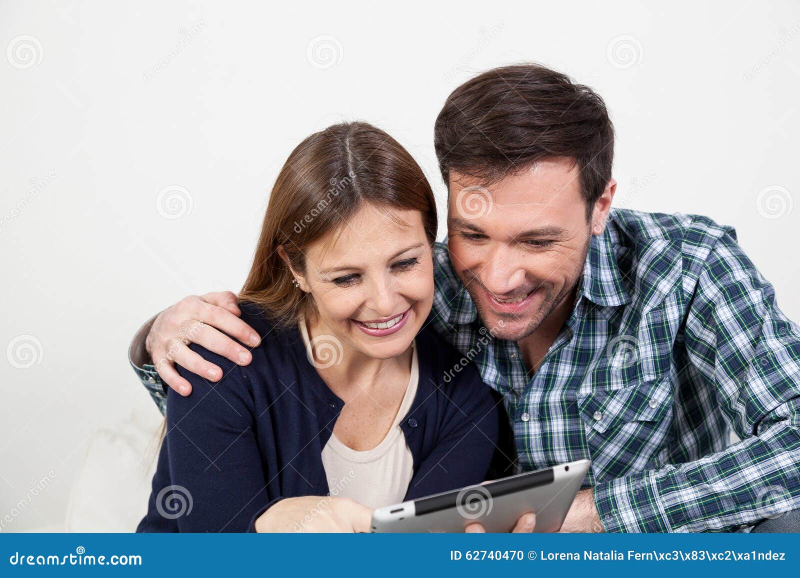 Couple using the ipad stock photo. Image of smiling, relaxed - 62740470
