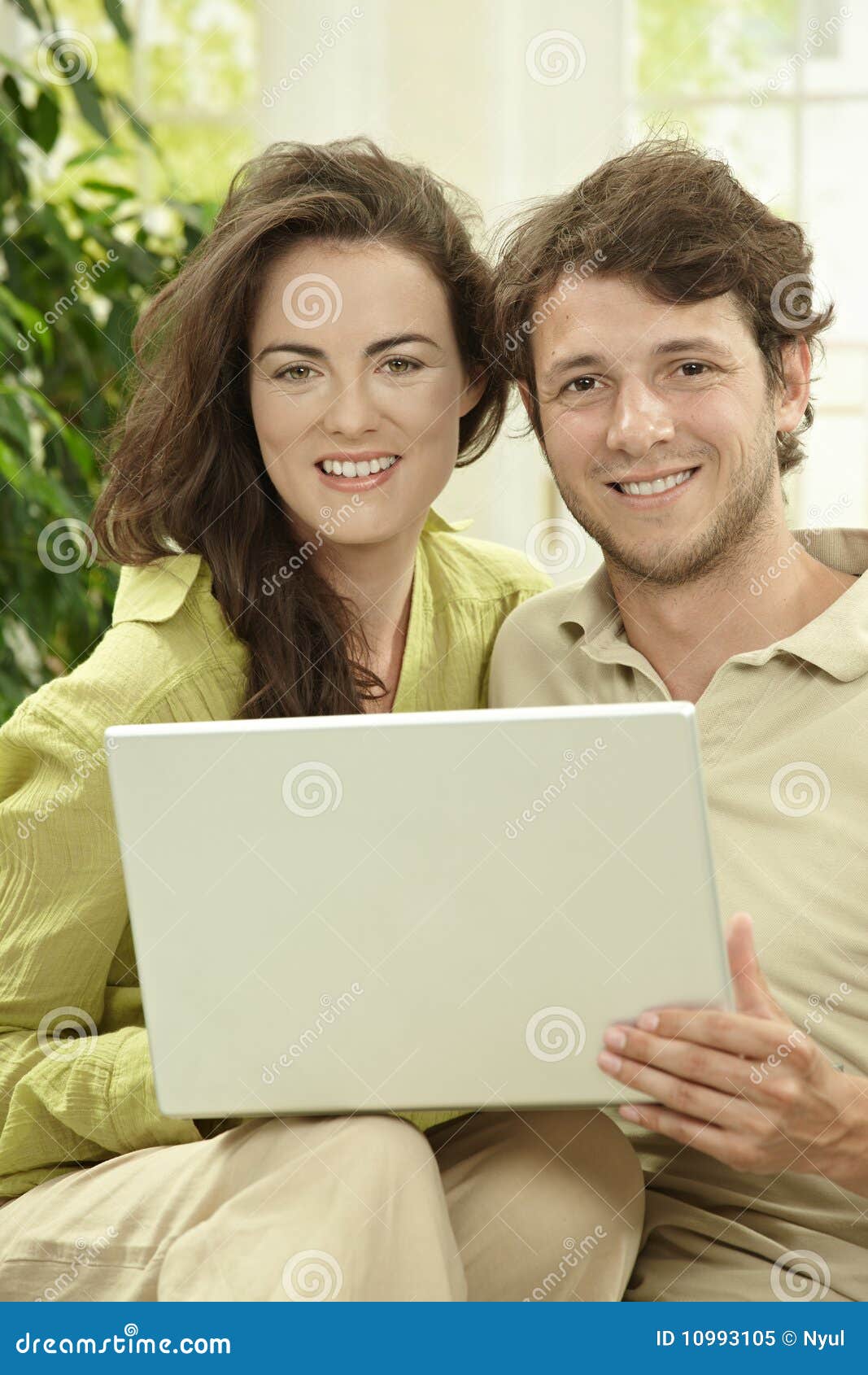 Couple using laptop stock image. Image of jeans, house - 10993105