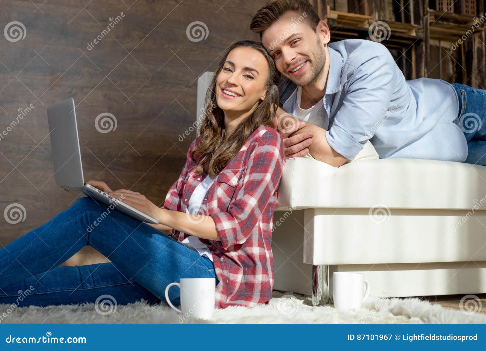 Couple Using Laptop at Home and Smiling at Camera Stock Image - Image ...