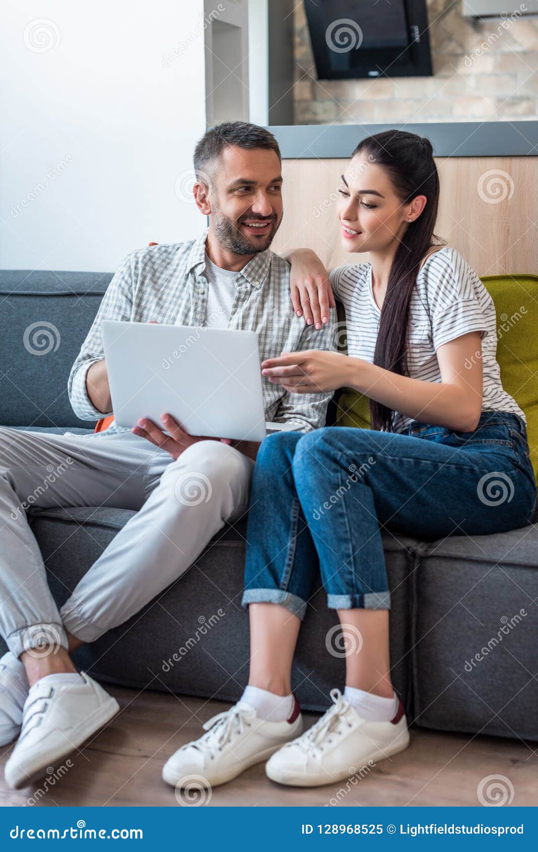 Couple Using Laptop Together While Resting On Sofa Stock Image Image