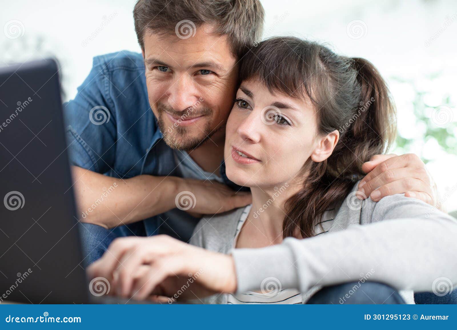 Couple Using Laptop Together when Sitting on Couch Stock Image - Image ...