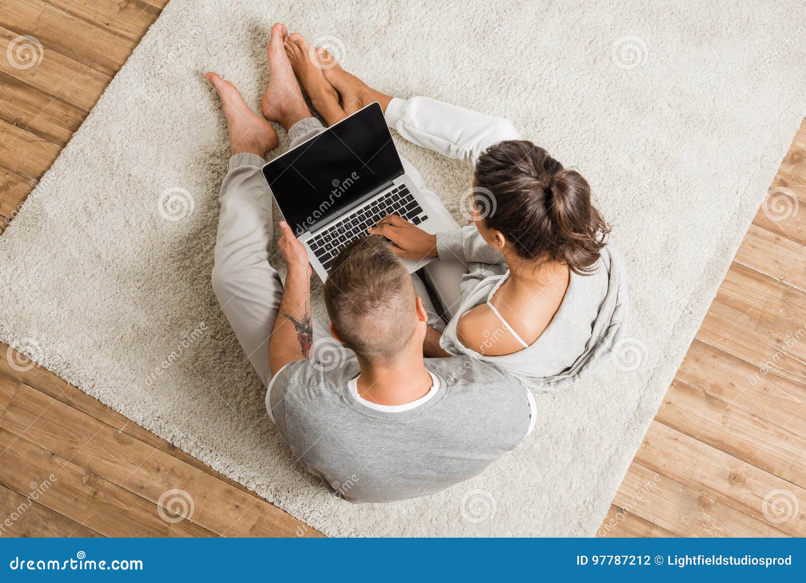 Couple Using Laptop Together while Sitting on Floor Stock Photo - Image ...