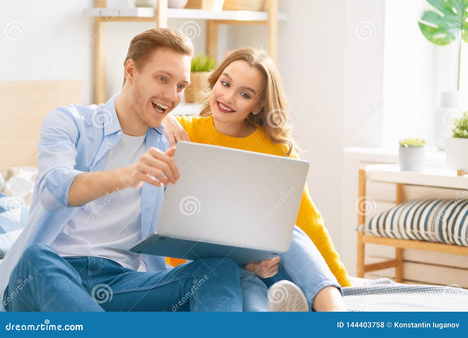 Couple is using a laptop stock photo. Image of beautiful - 144403758